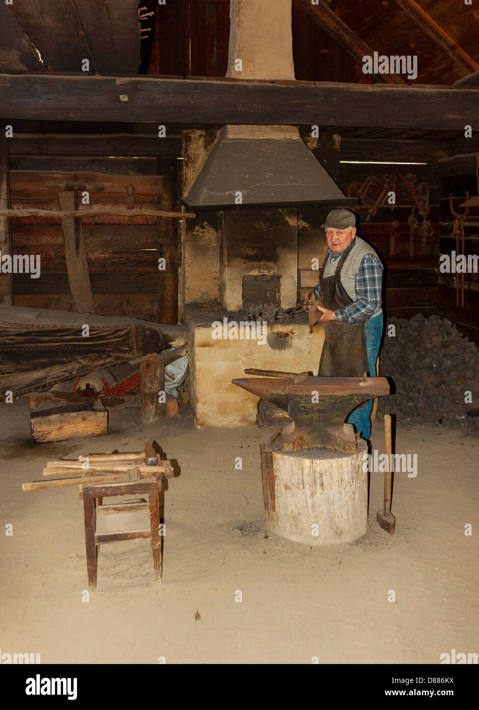 Blacksmith at work in smithy that comes from Żuromin town, now located ...