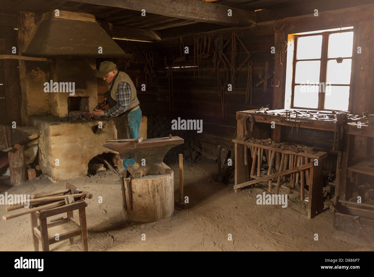 Blacksmith at work in smithy that comes from Żuromin town, now located ...