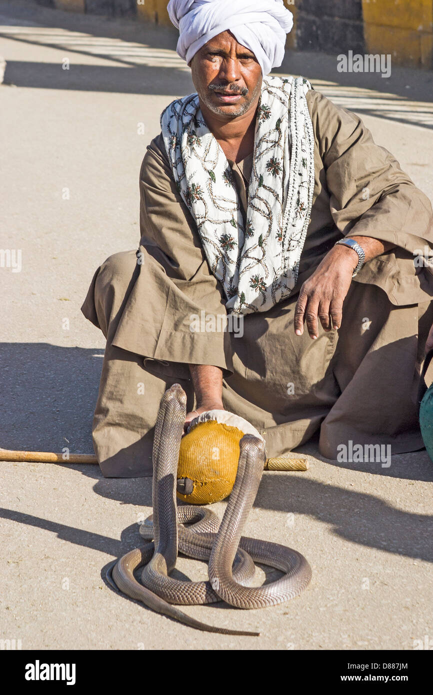 Snake charmer in Esna, Upper Egypt with two cobras - Egyptian Arab with ...