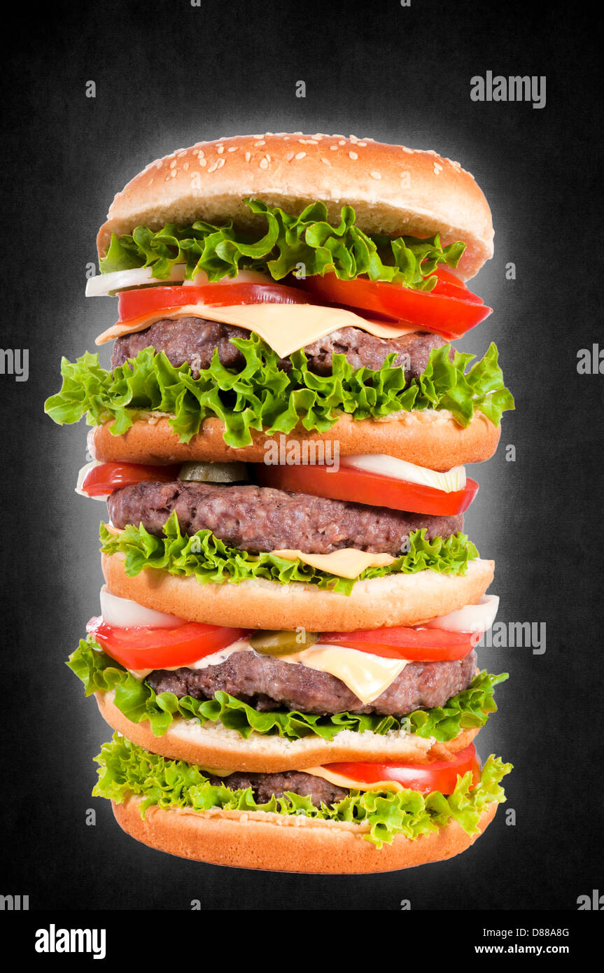 Big cheeseburger isolated on black Stock Photo - Alamy
