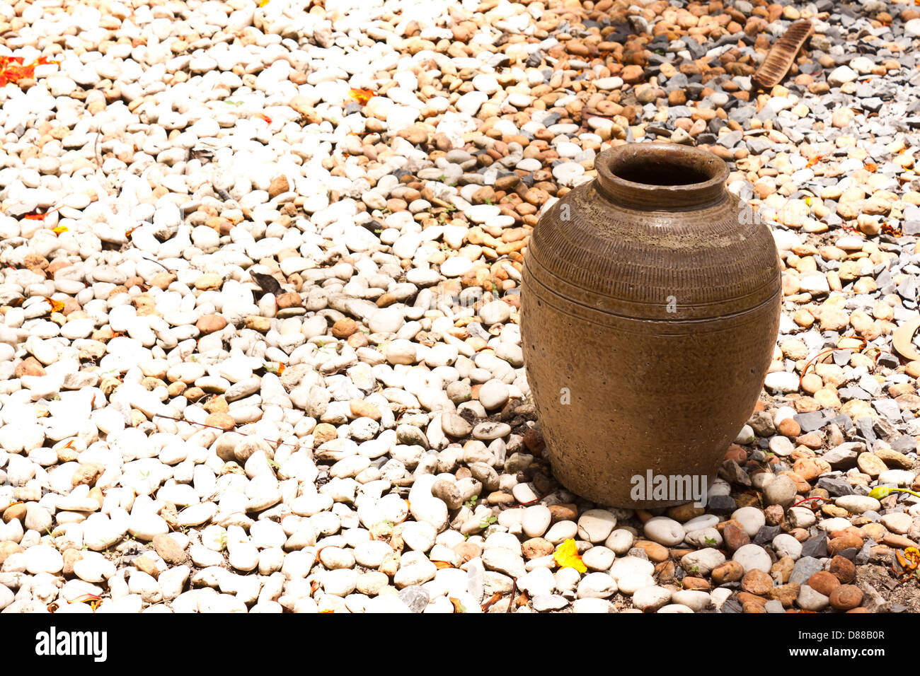 jar on a small white stone Stock Photo - Alamy