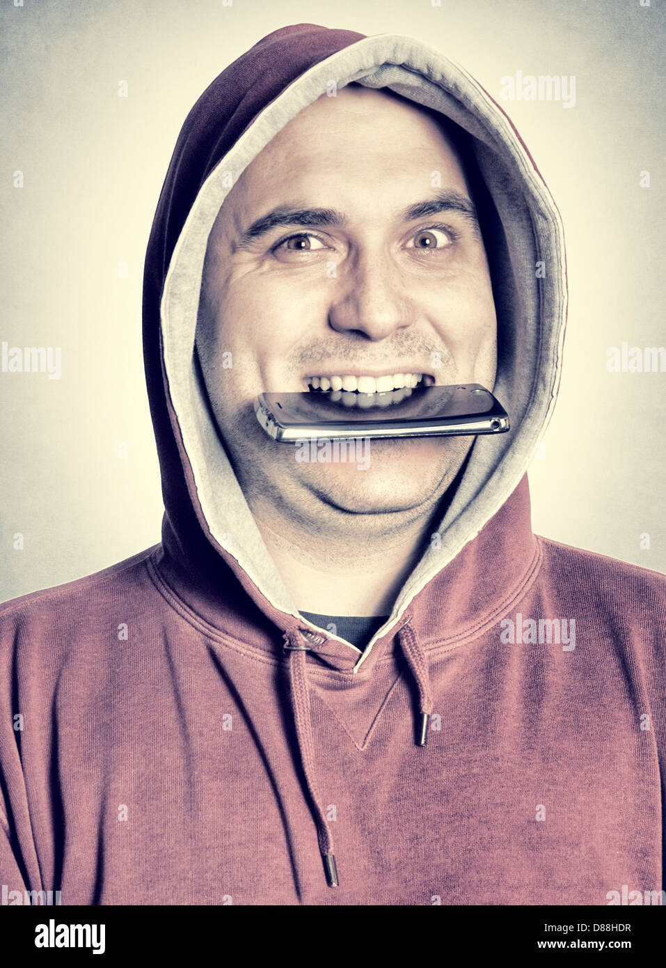 Funny man eating his cell phone Stock Photo - Alamy
