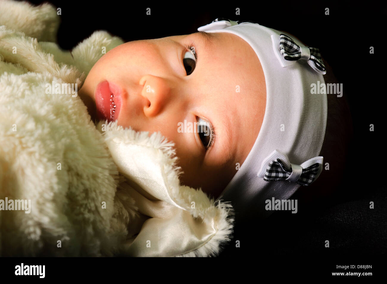 Serious baby face. Shoot in low key technique Stock Photo - Alamy