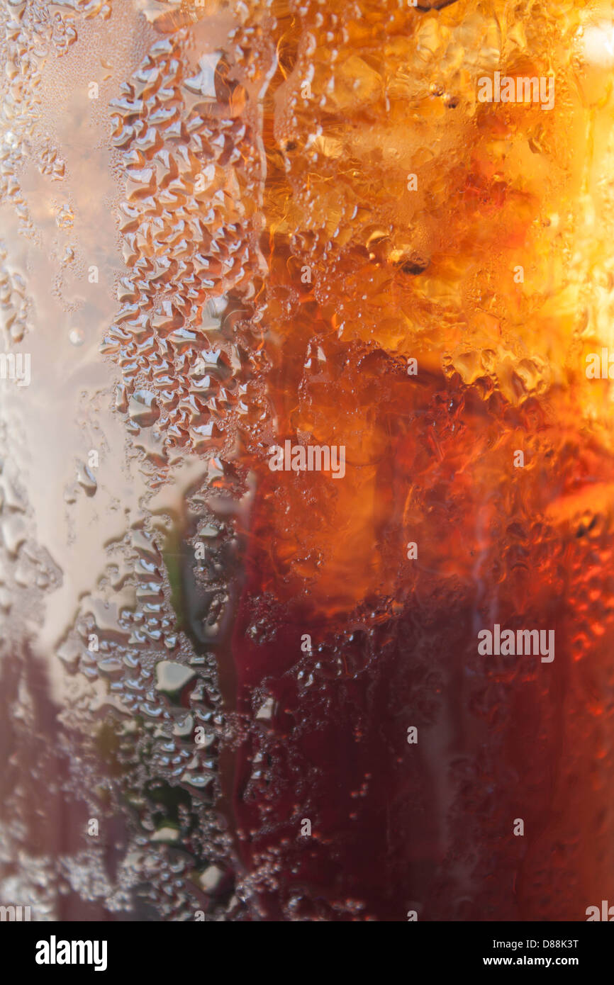 Fizzy cola in a glass with ice cubes Stock Photo - Alamy