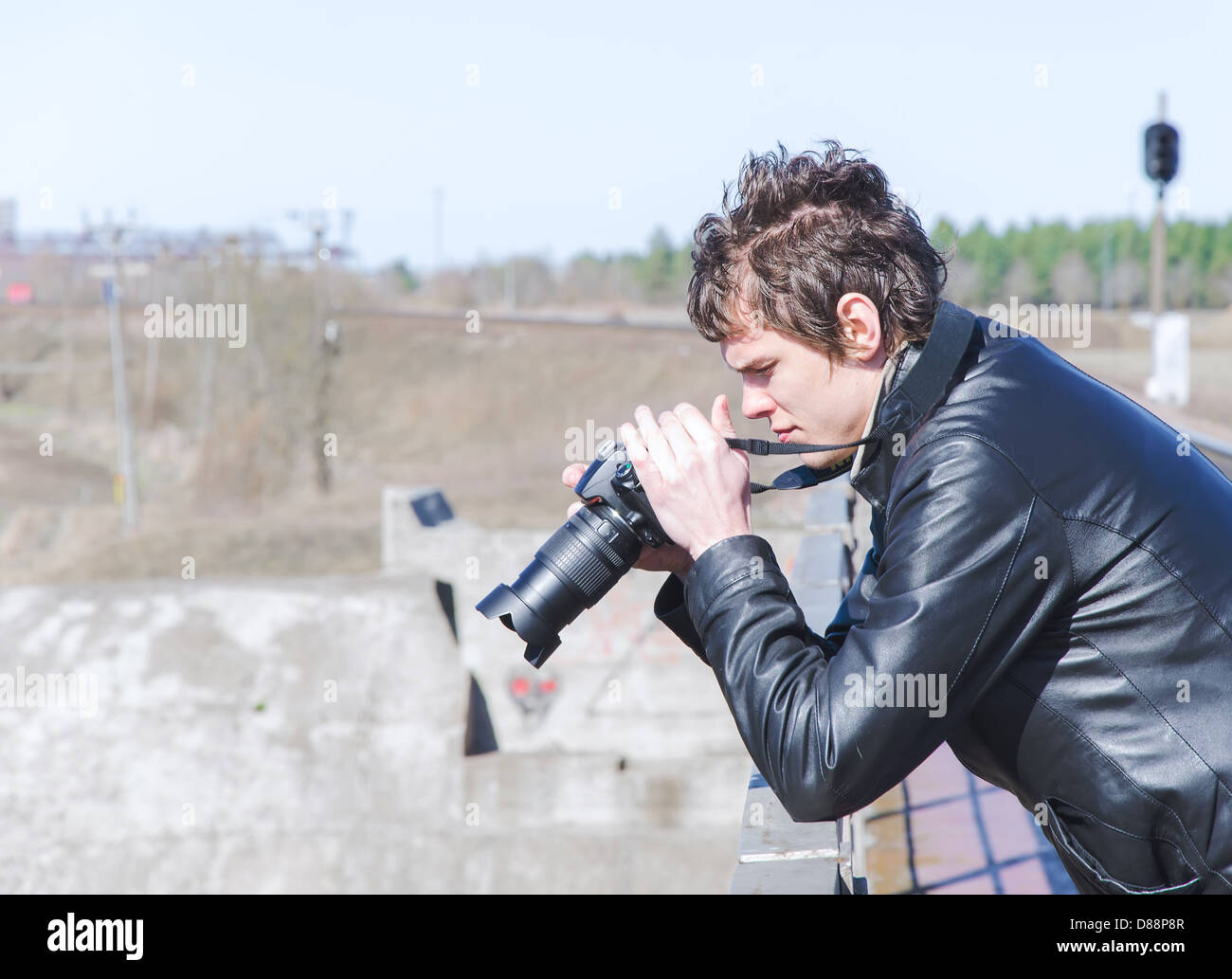 Nature photographer looking at pictures through camera screen Stock ...