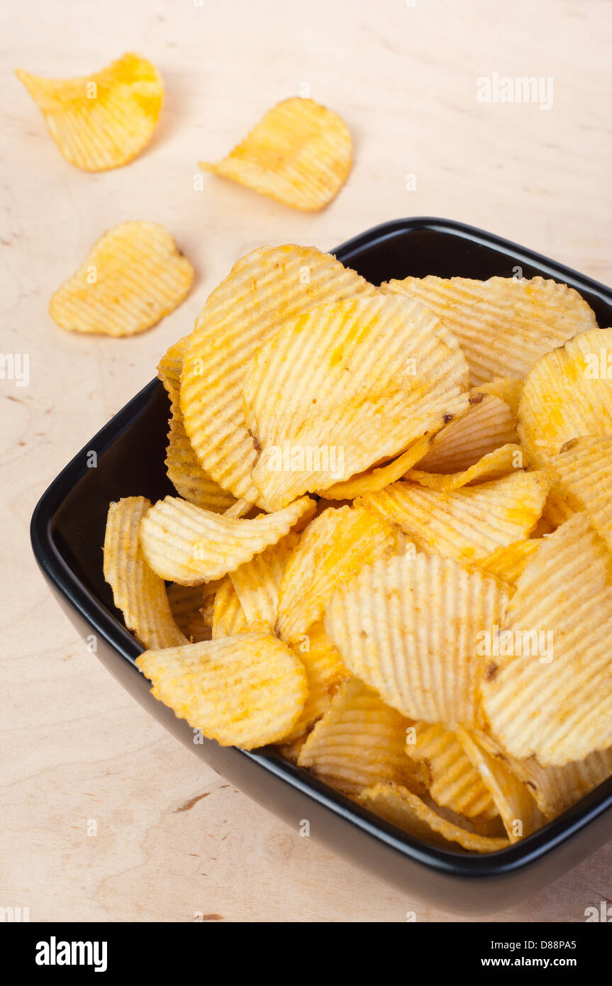 Bowl of potato chips in the composition Stock Photo - Alamy