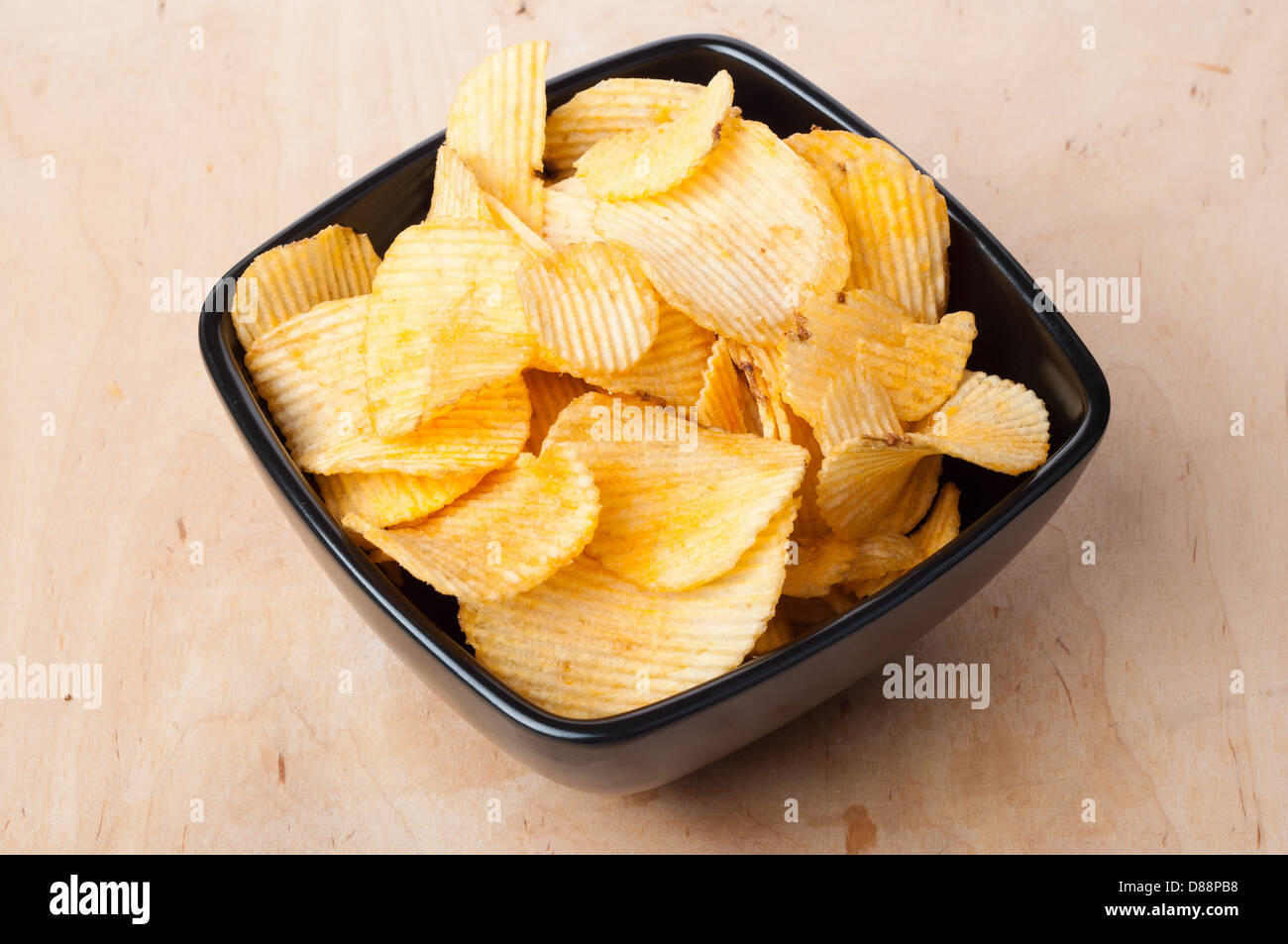 Bowl of potato chips in the composition Stock Photo - Alamy