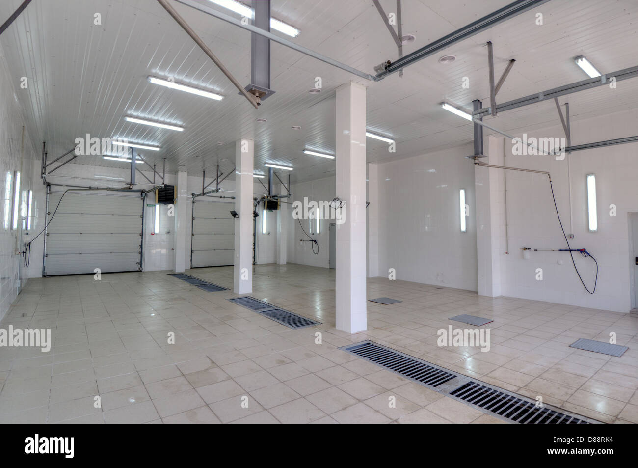 interior space car wash with a pump in the foreground Stock Photo - Alamy