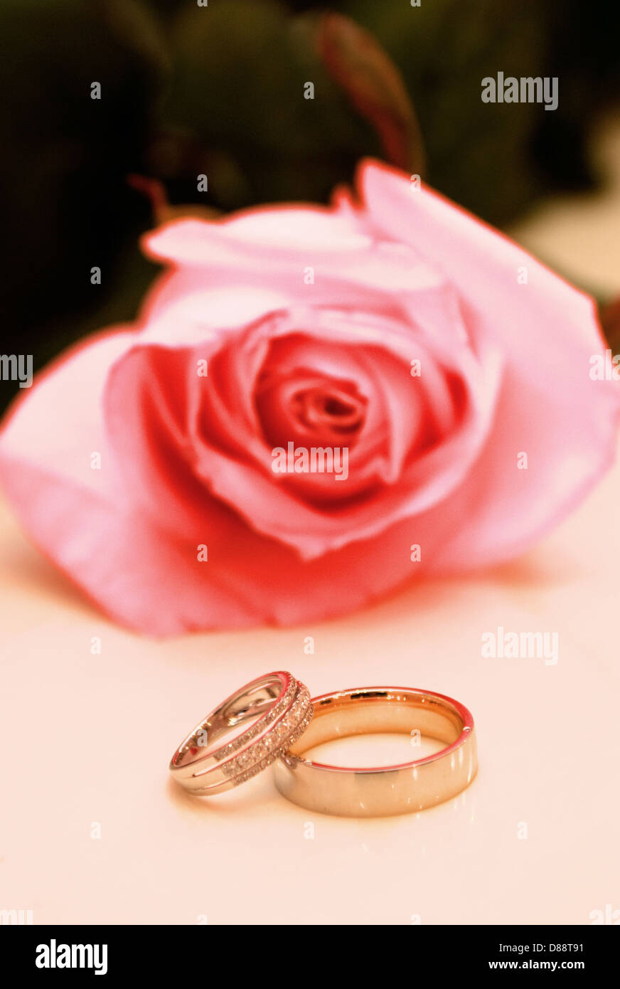 Two Golden Wedding Rings on table macro shot Stock Photo - Alamy