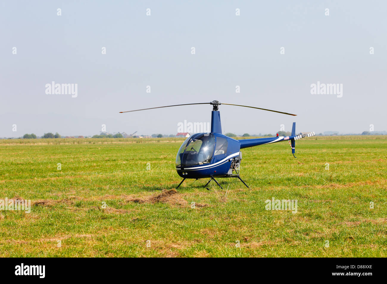 Helicopter on green field Stock Photo - Alamy