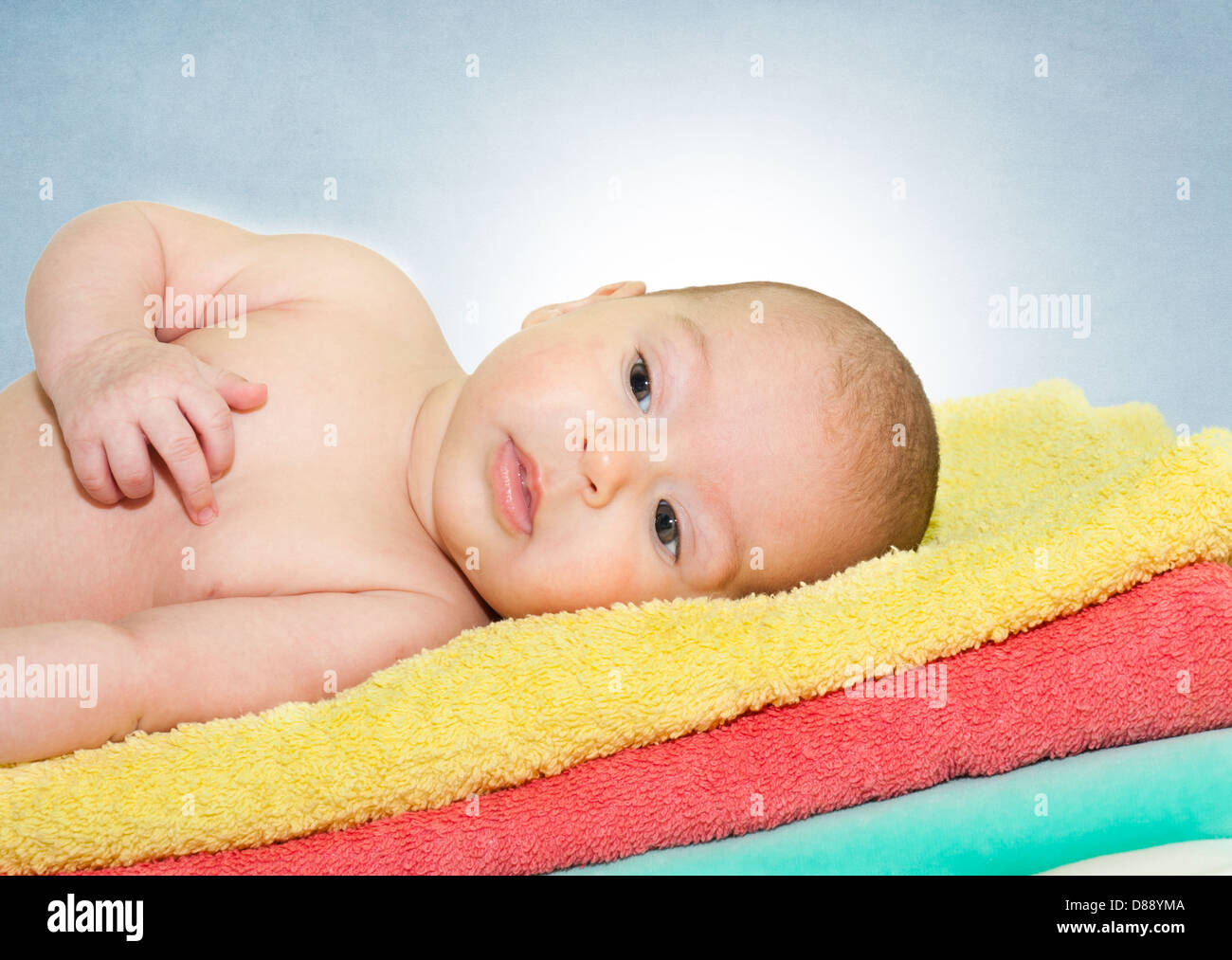 Baby chilling on the towels Stock Photo - Alamy