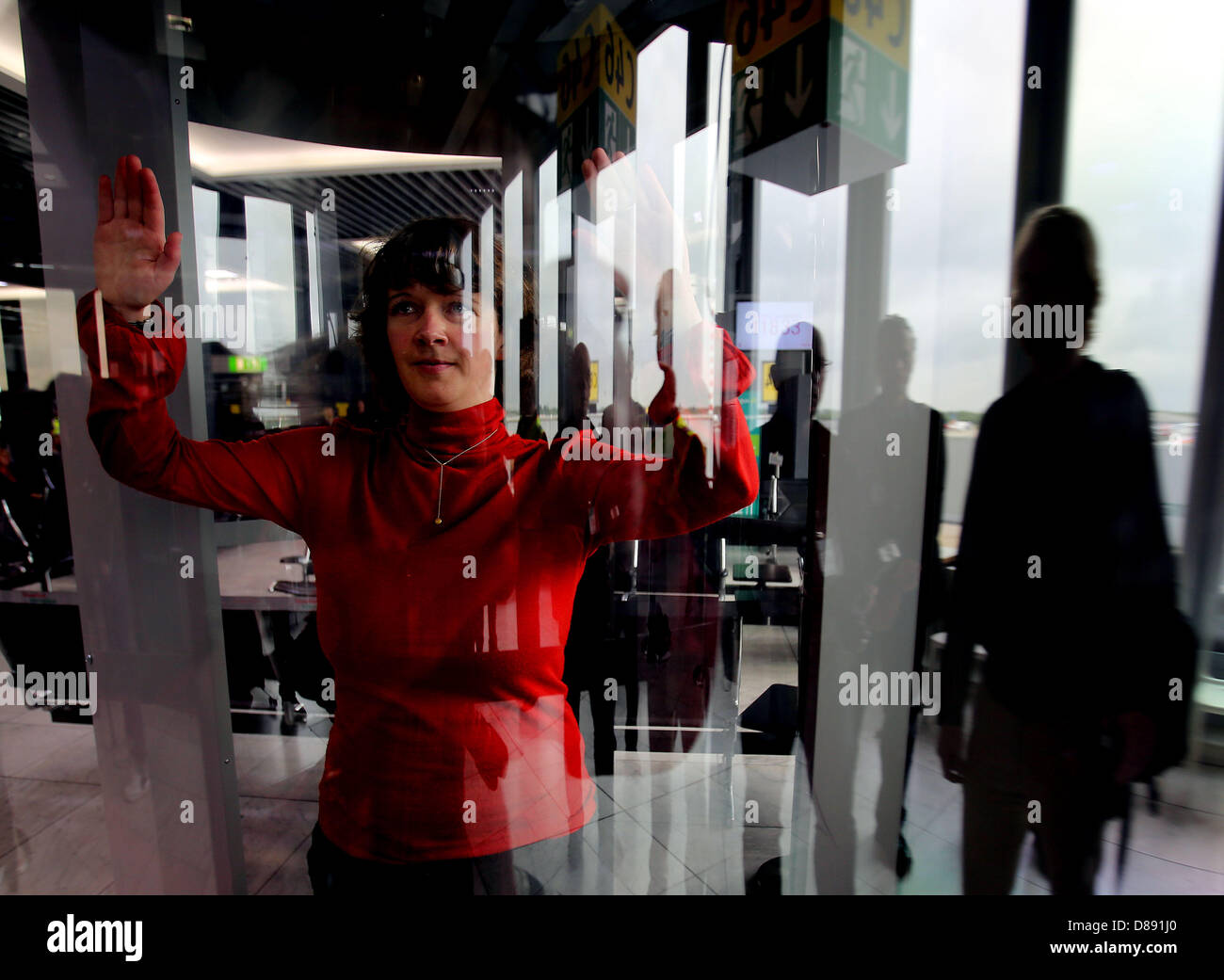 A woman stands in a body scanner at the airport in Duesseldorf, Germany ...
