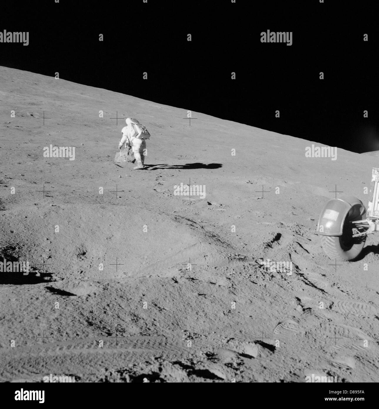 Apollo 15 astronaut David Scott is seen near a large boulder at Station ...