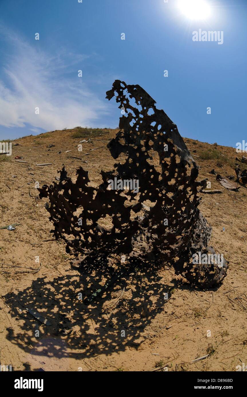 A metal plate, destroyed and deformed by metal splinters, is pictured ...