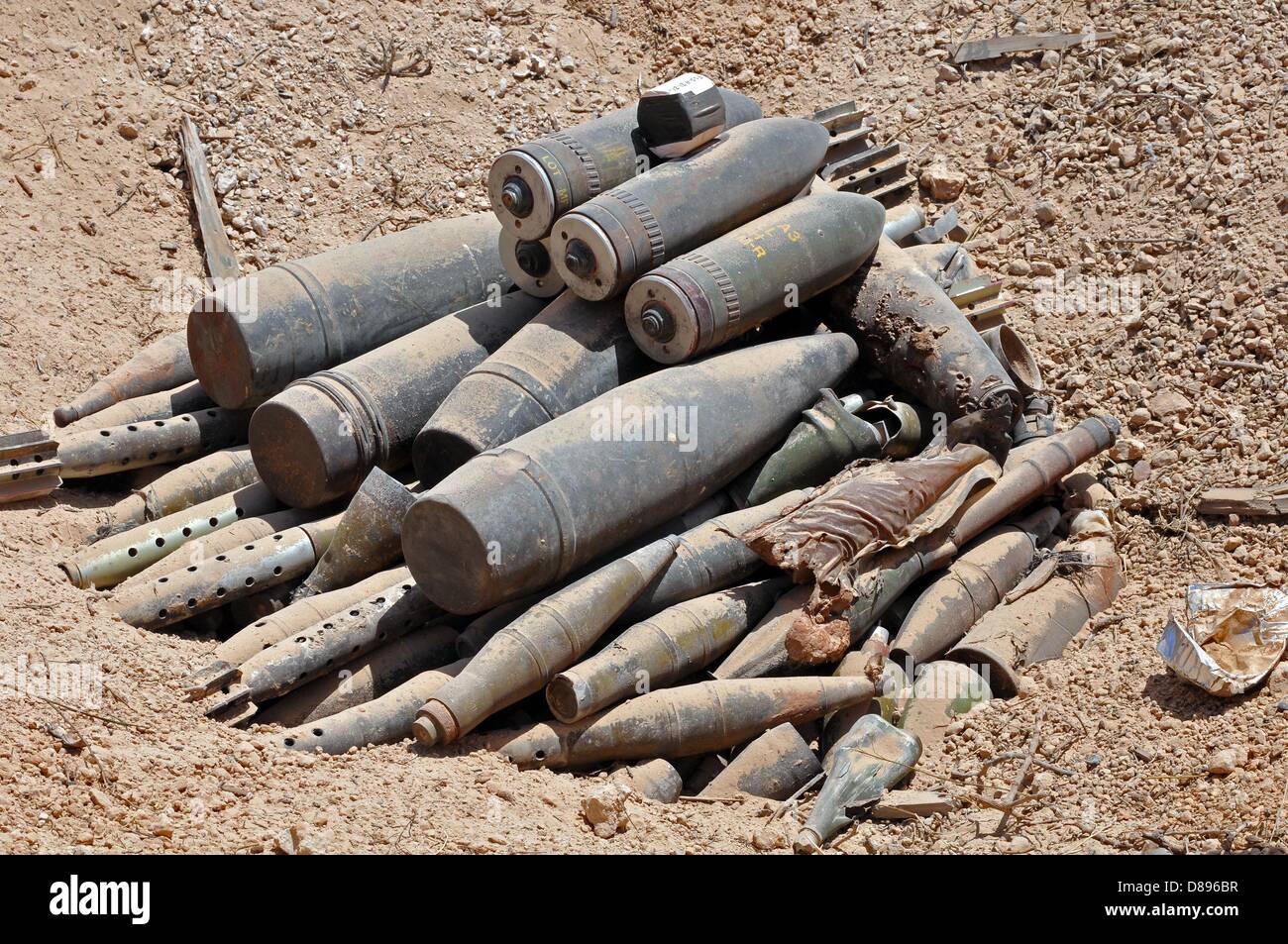 A pile of collected mines, ammunition, and explosives, which are about ...