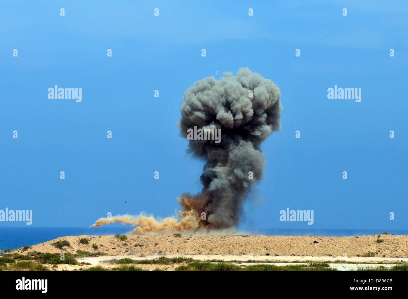 A controlled explosion of ammunition remnants is pictured from a ...