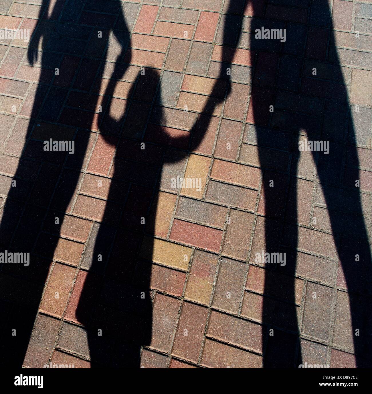 Shadows of a mother, father and child are the only thing to be seen on ...