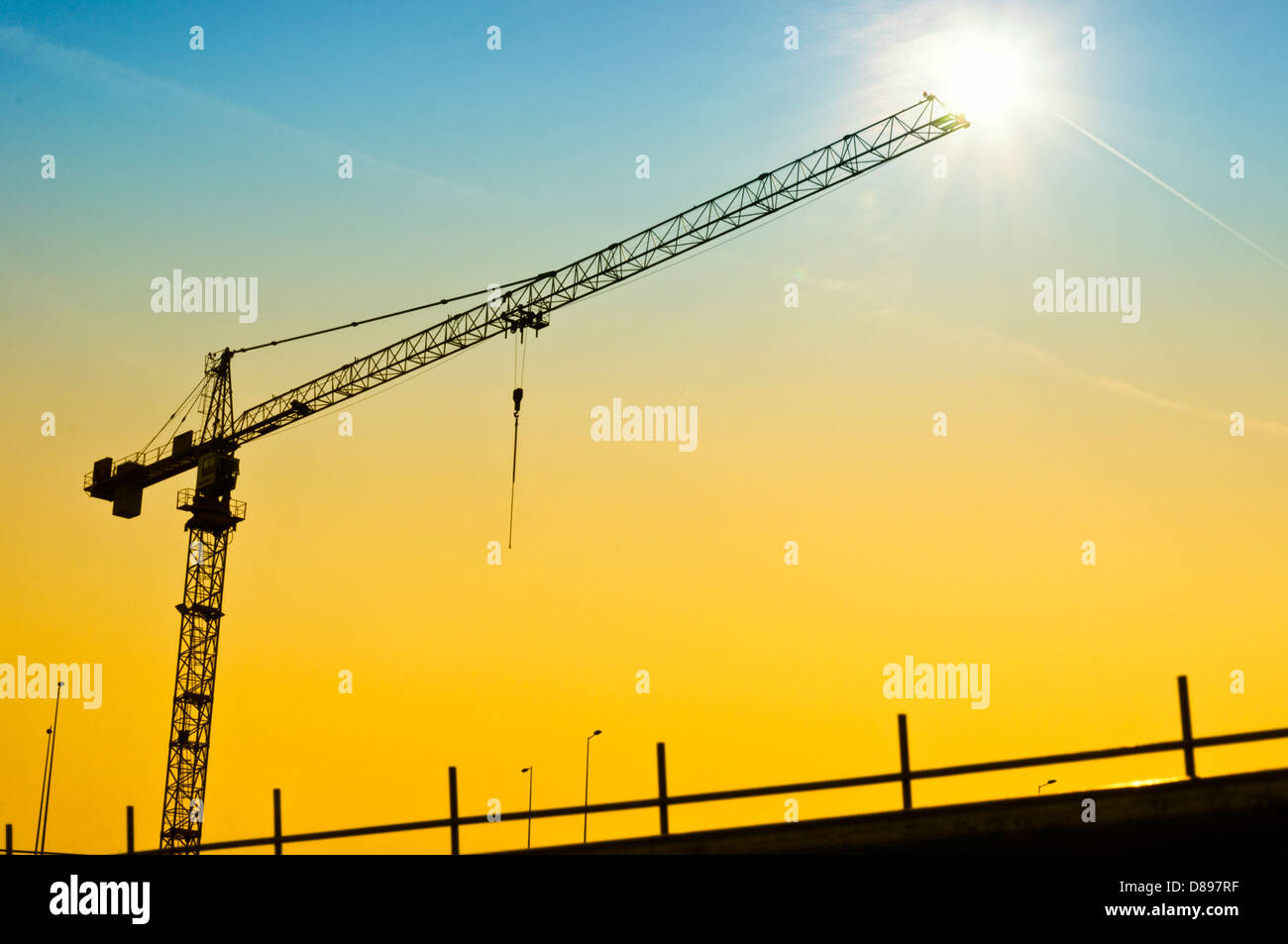 Sunset over the construction crane Stock Photo - Alamy