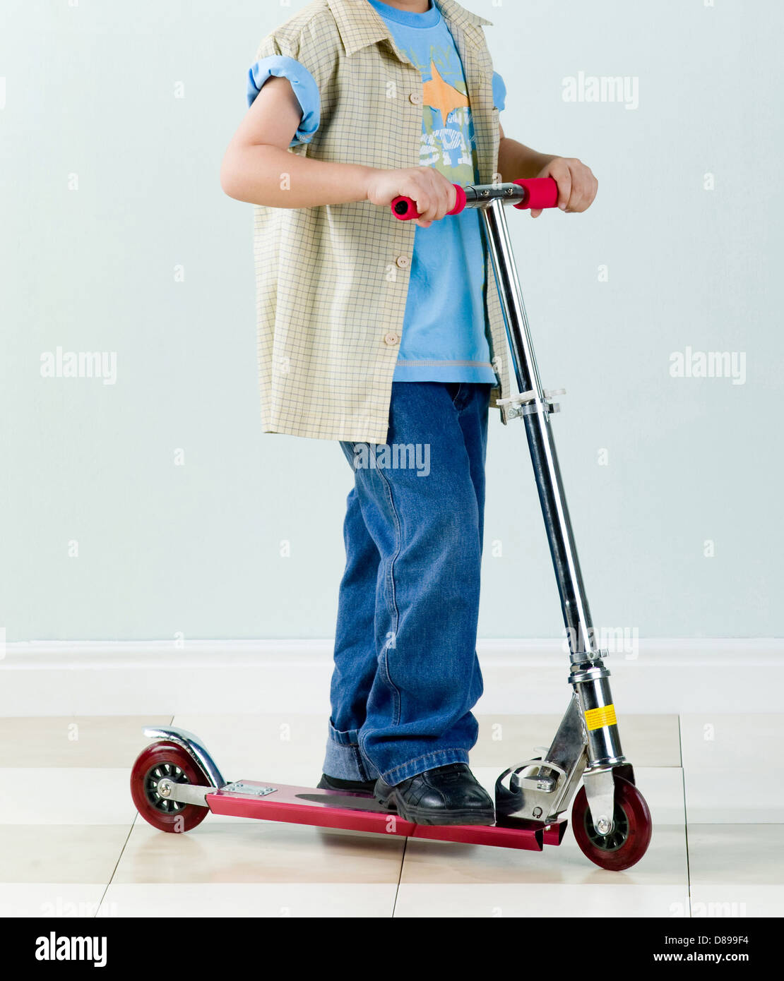 a boy rides a scooter for fun and exercise Stock Photo - Alamy