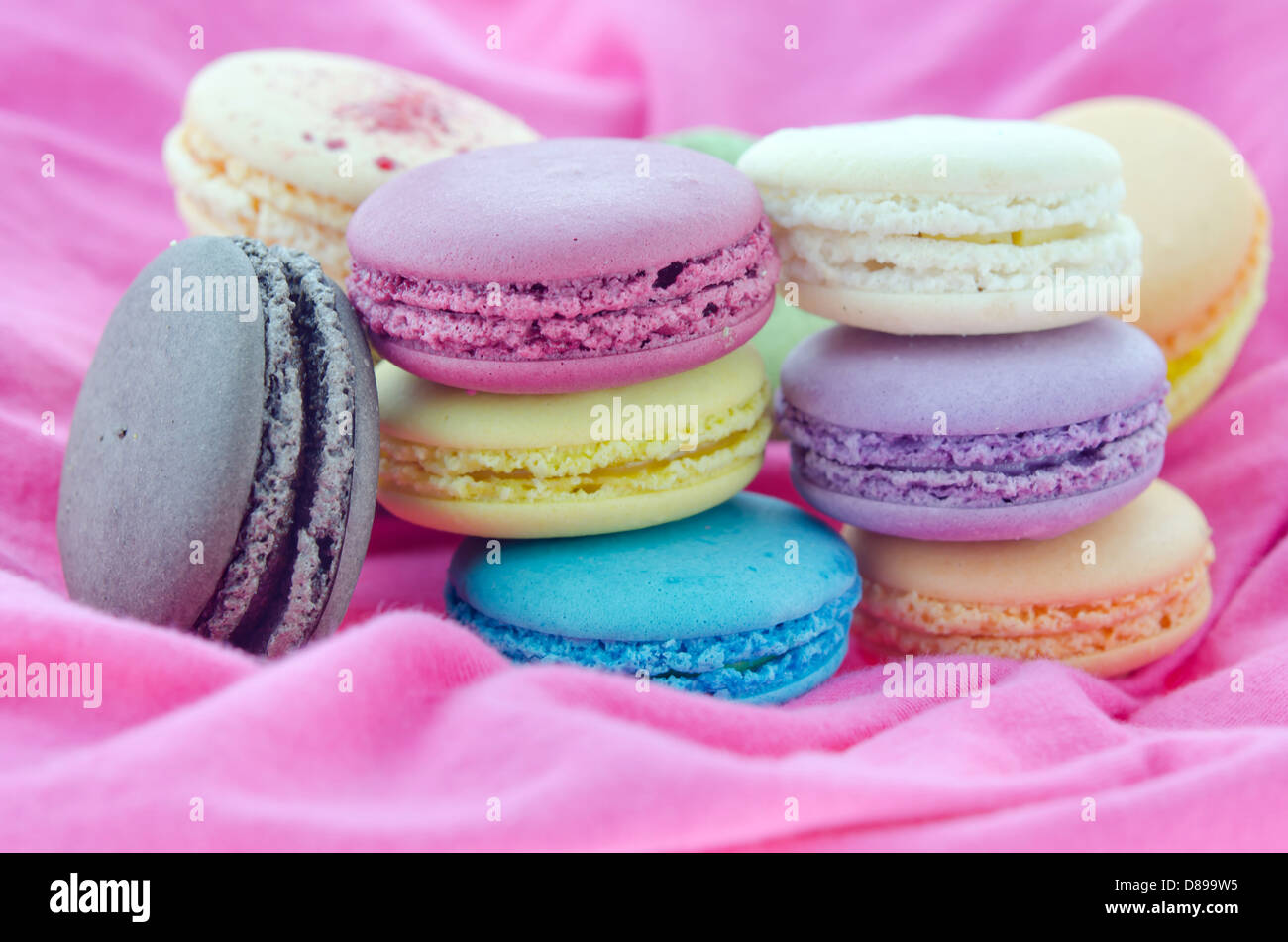 colorful french macaroons stack on pink fabric Stock Photo - Alamy
