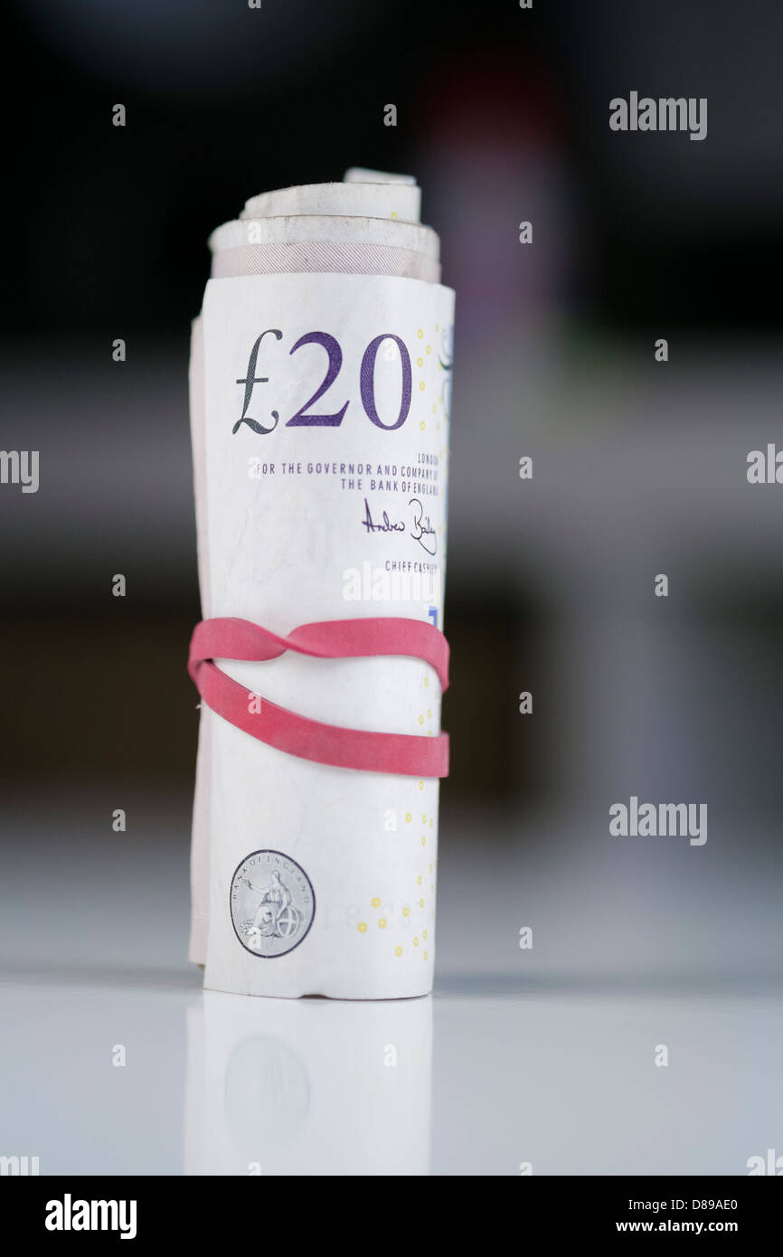 A roll of twenty pound notes on a table Stock Photo - Alamy