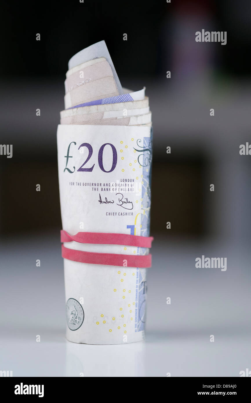 A roll of twenty pound notes on a table Stock Photo - Alamy