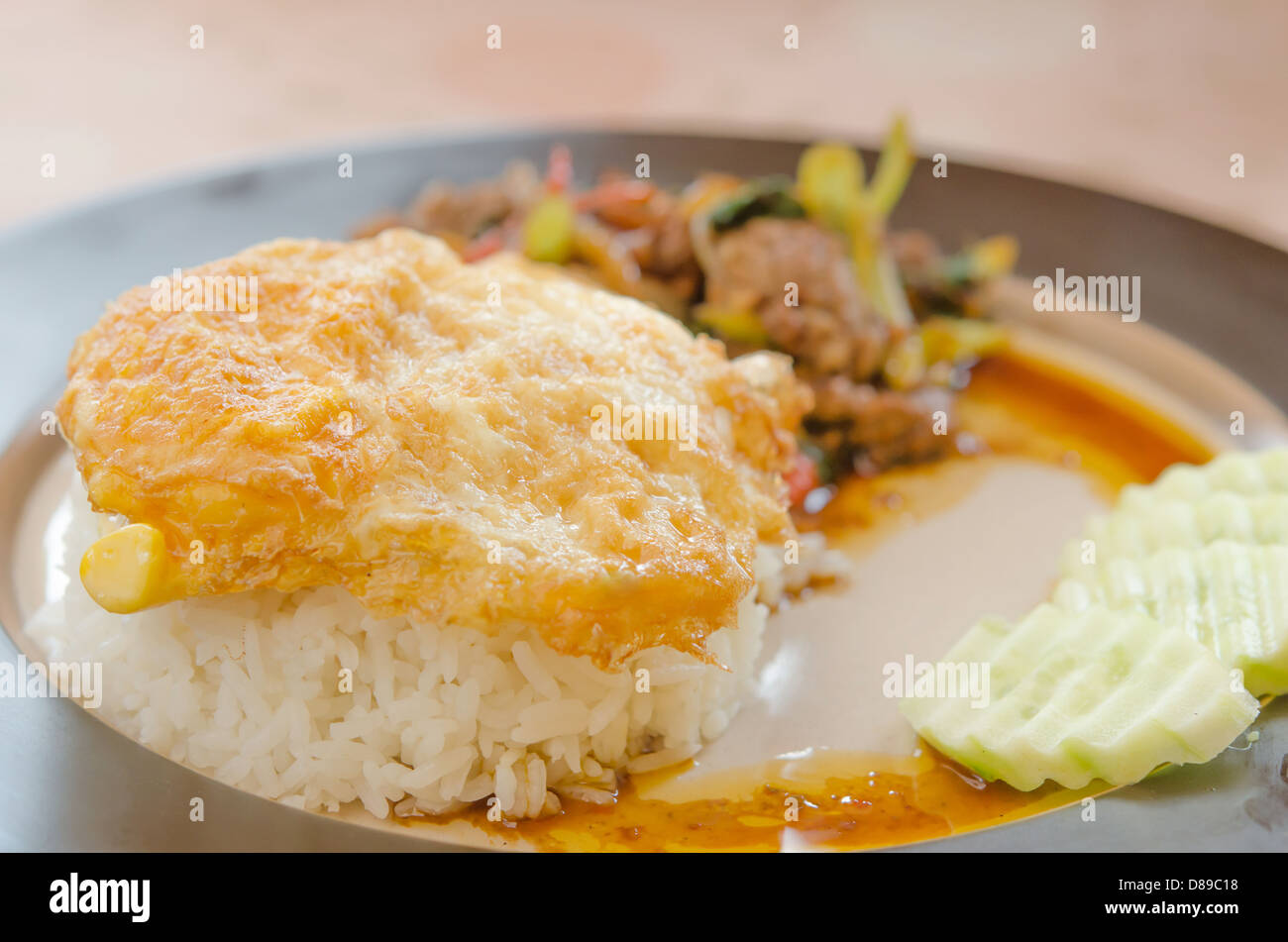 close up fried egg over rice and pork fried with chili pepper , sweet ...