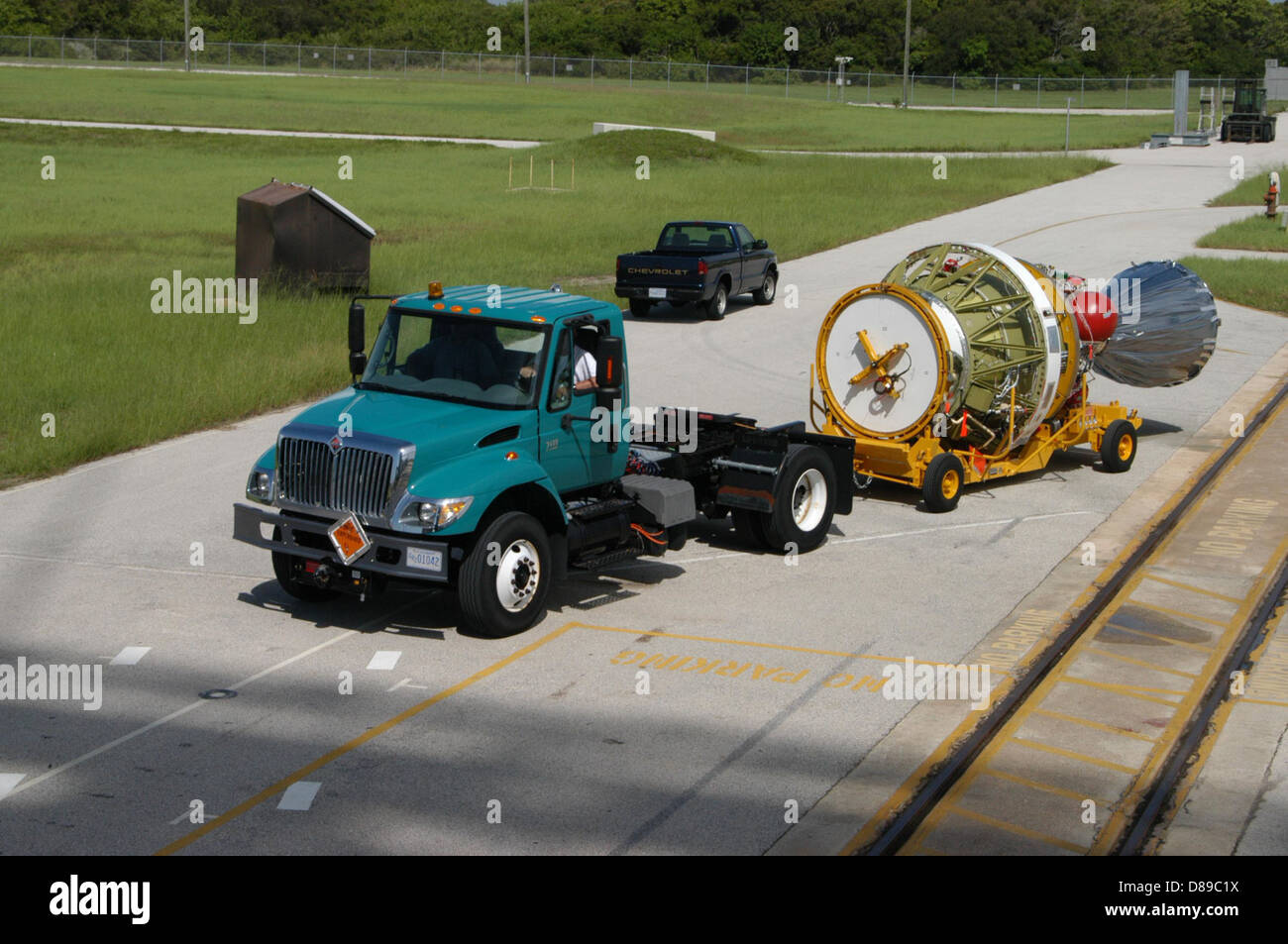 The Delta II rocket's second stage is seen being transported on a truck ...