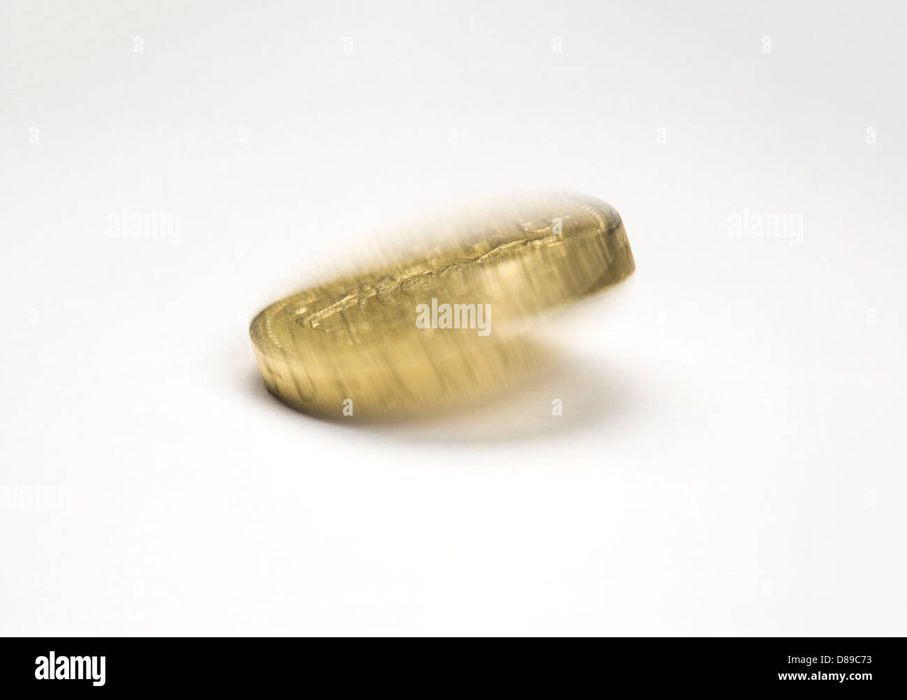 A spinning British pound coin Stock Photo - Alamy