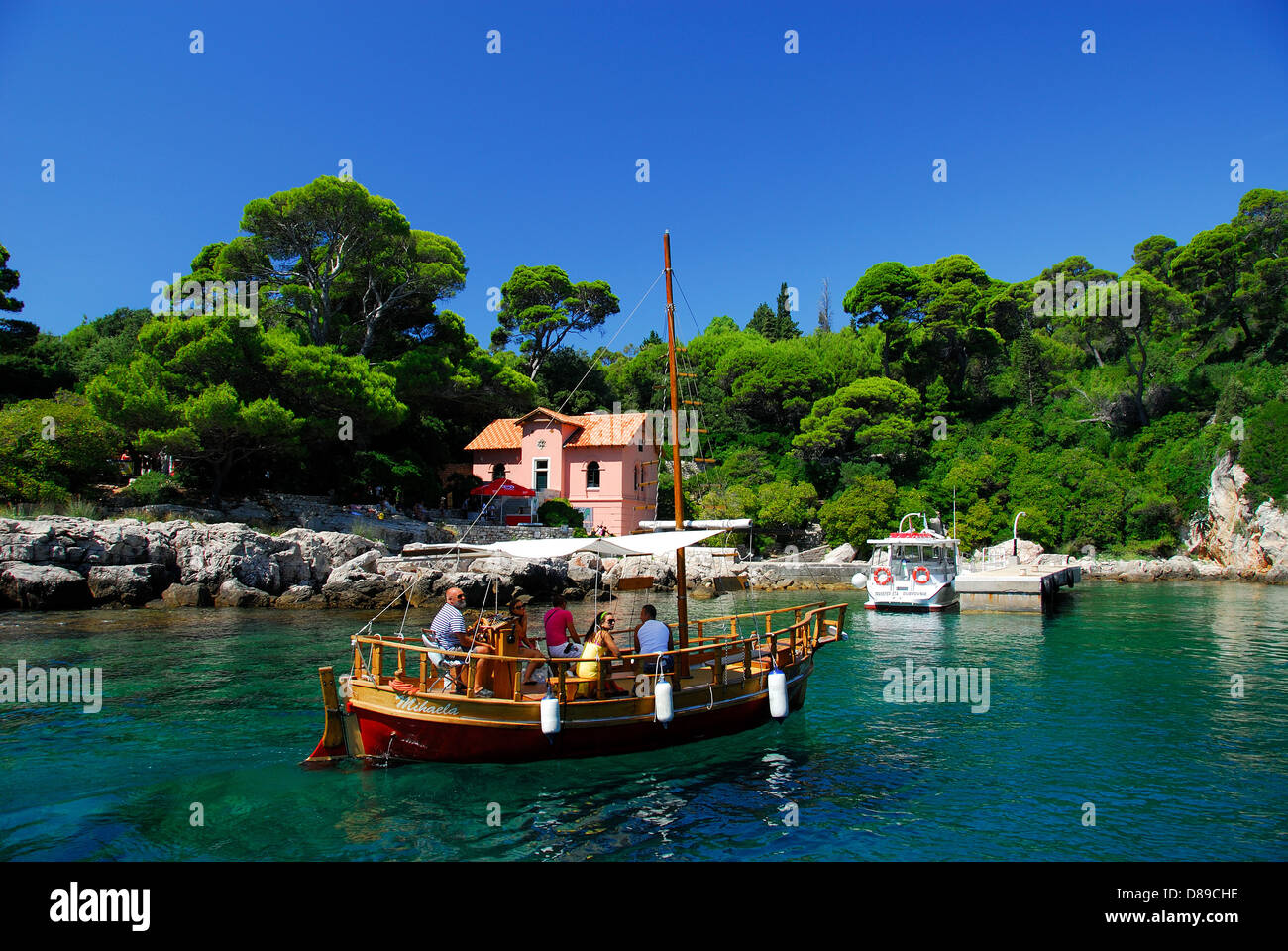 DUBROVNIK, CROATIA. A small boat carrying daytrippers arriving at ...