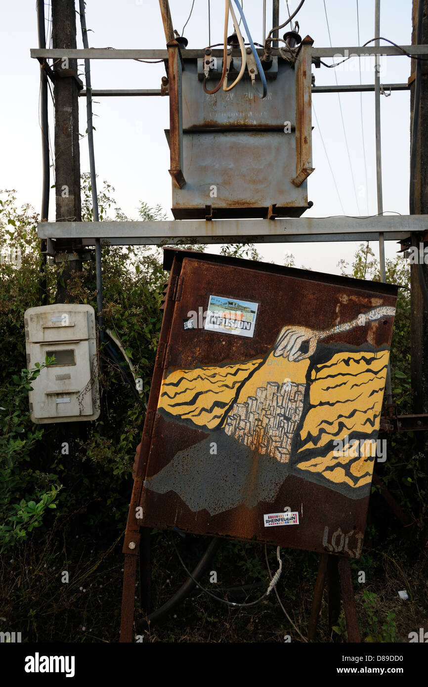 Rusted electrical distribution poles with mural Stock Photo - Alamy