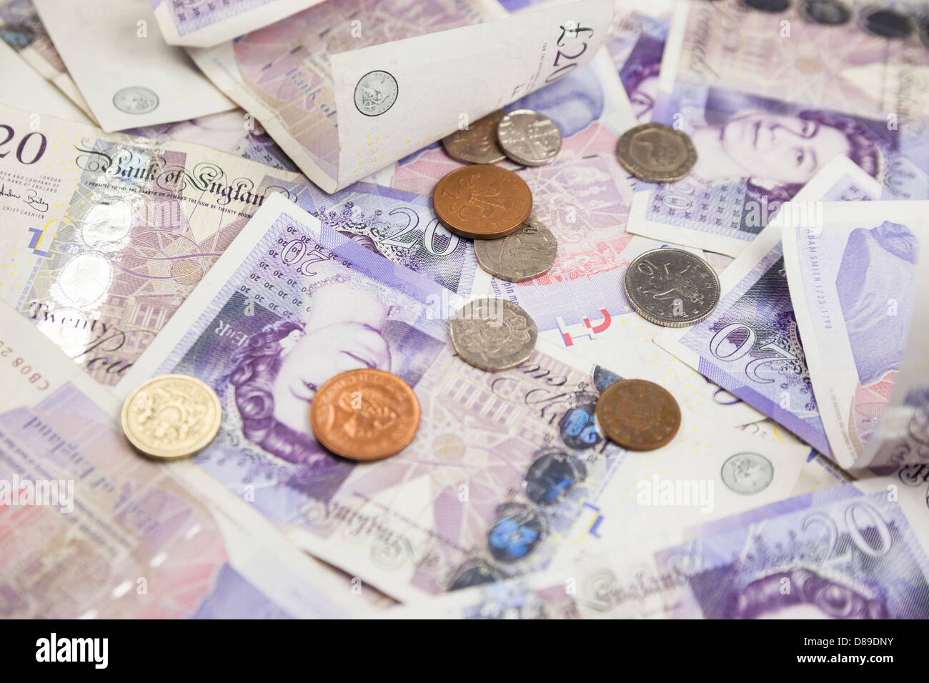Twenty pound notes and coins on a table Stock Photo - Alamy