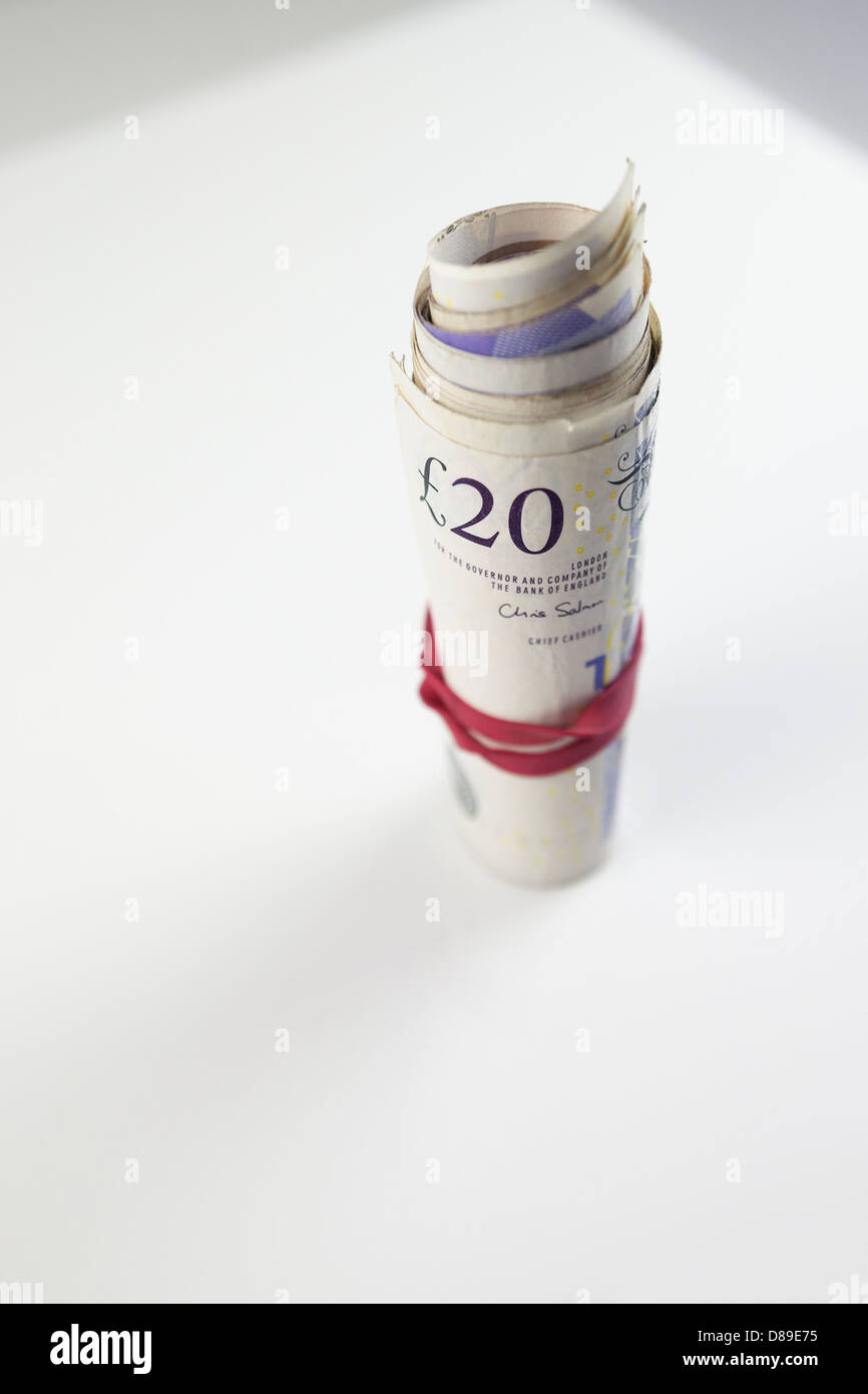A roll of twenty pound notes on a table Stock Photo - Alamy