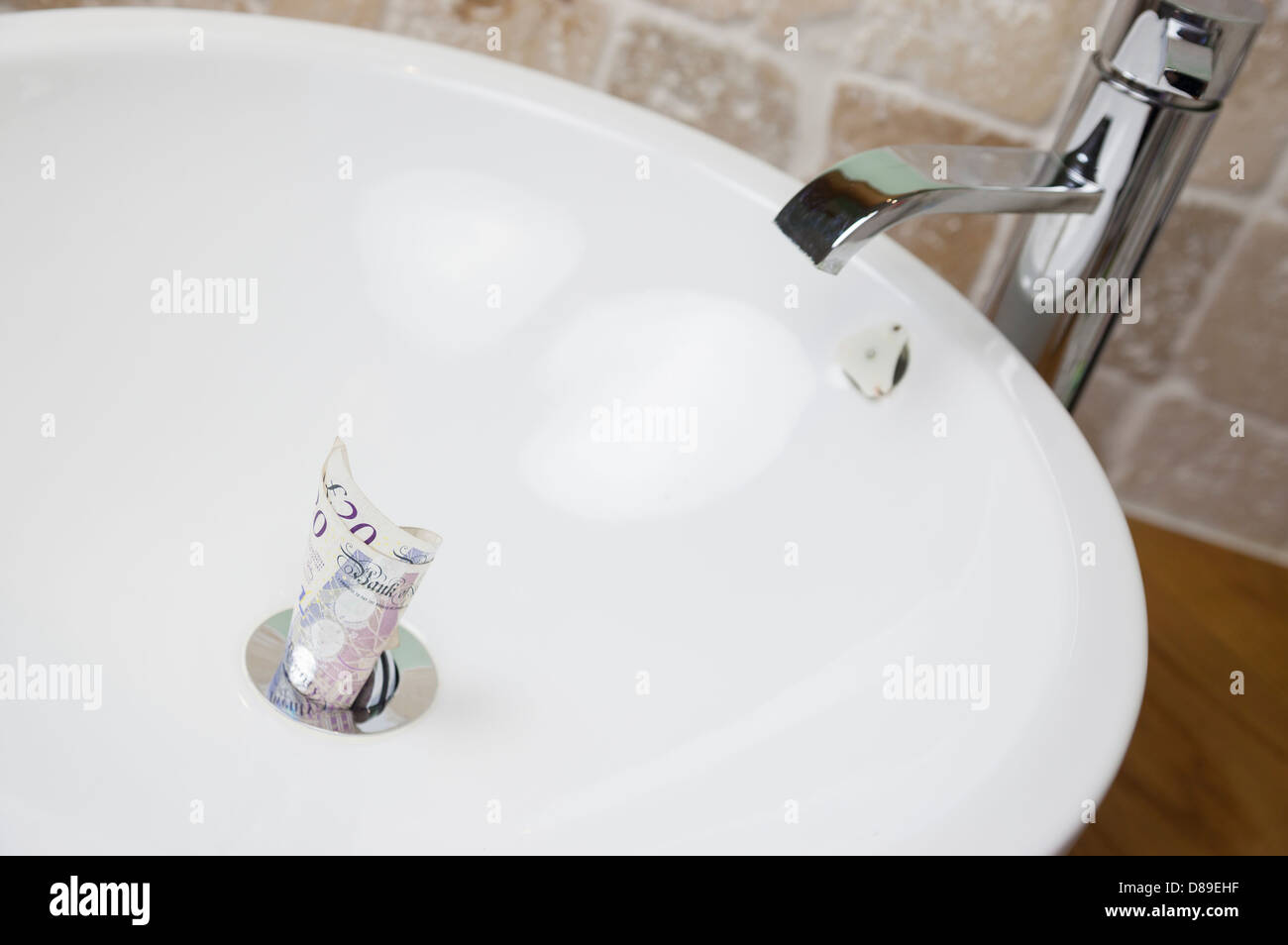 Throwing money down the drain hi-res stock photography and images - Alamy