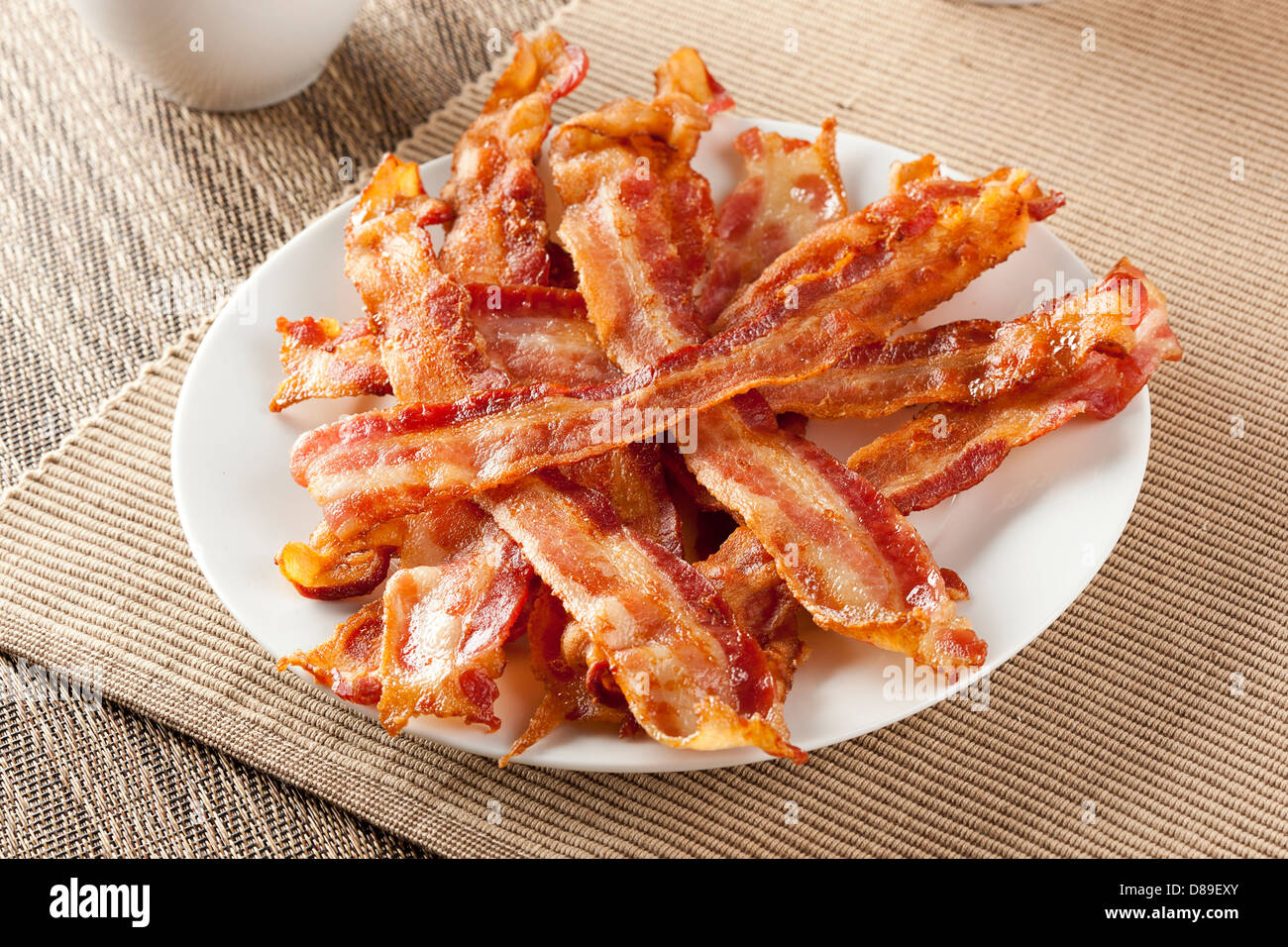 Cooked Greasy Bacon against a back ground Stock Photo - Alamy