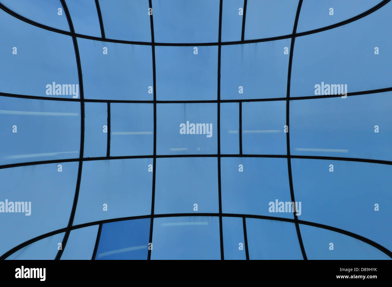 Distorted glass facade of modern building. Abstract architectural ...