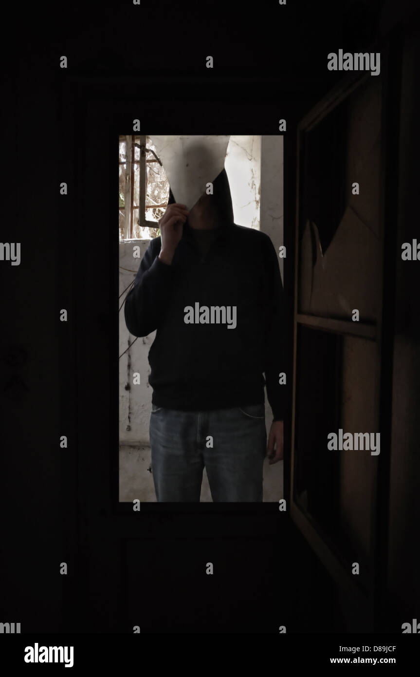 Broken window and man holding a piece of glass in abandoned house Stock ...