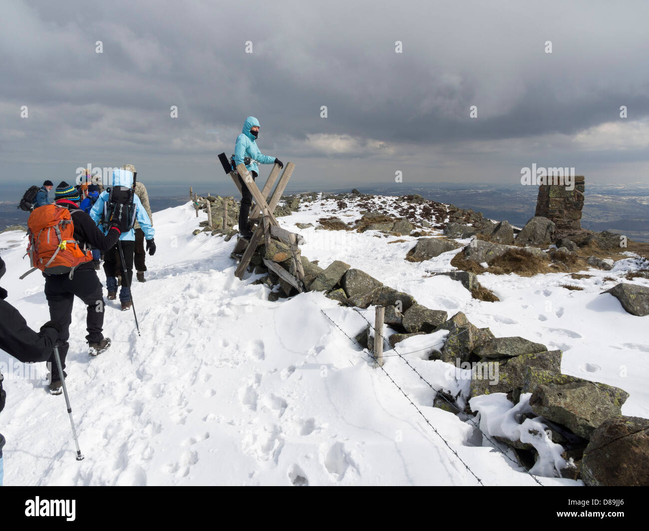 Group of Ramblers walking in snow on summit of Tal y Fan mountain in ...