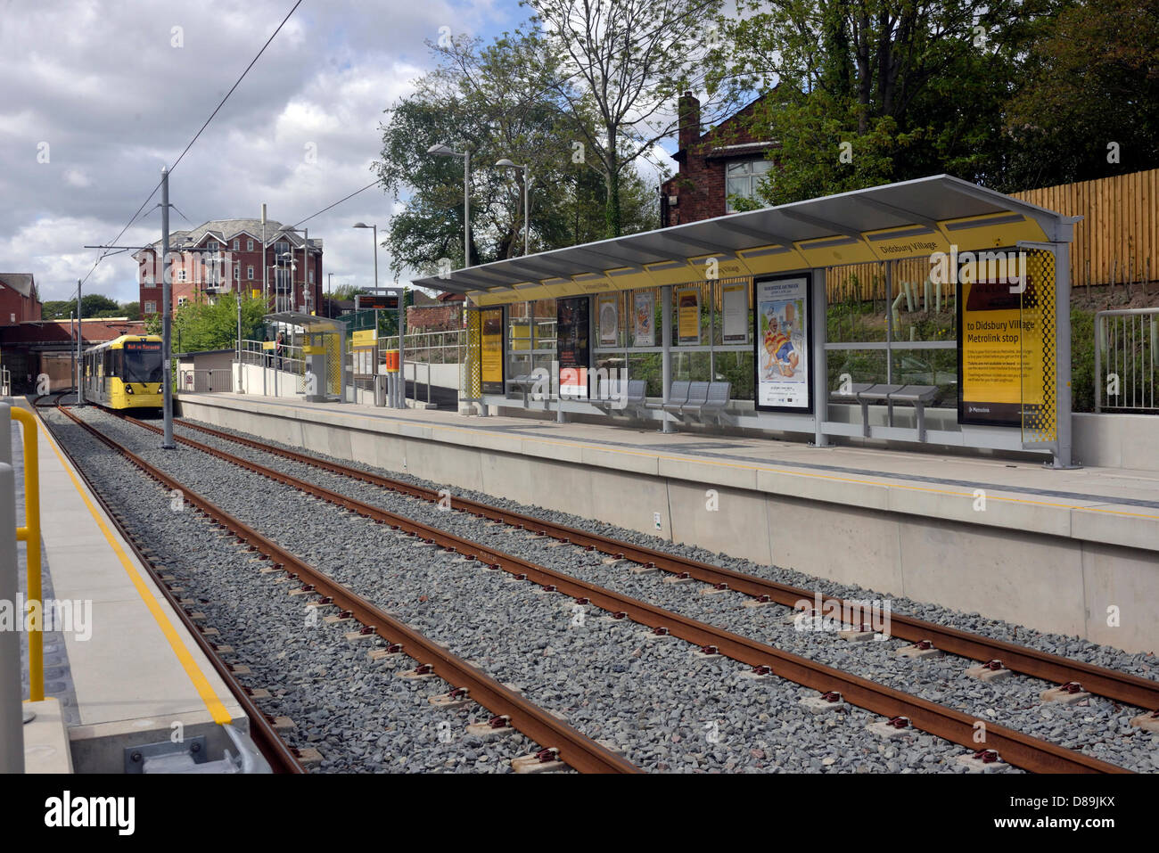 Didsbury Village, Manchester, UK . 22nd May 2013. A train passes ...