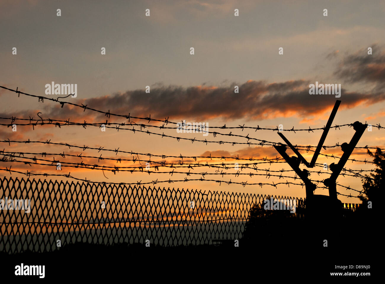Sunset behind barbed wire. Remnants of the Iron Curtain Stock Photo - Alamy