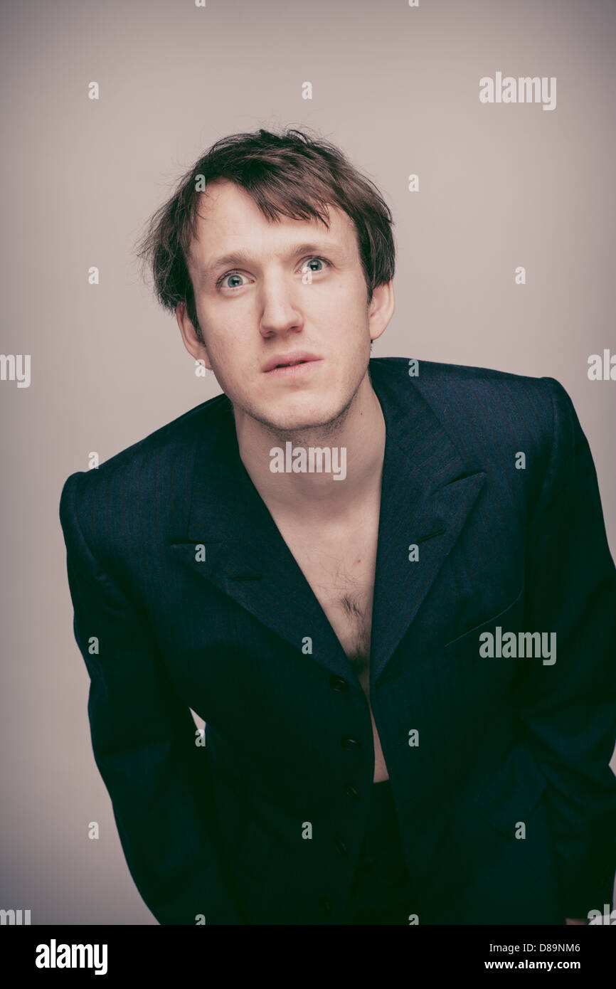 Curious man, shirtless, in suit jacket Stock Photo - Alamy