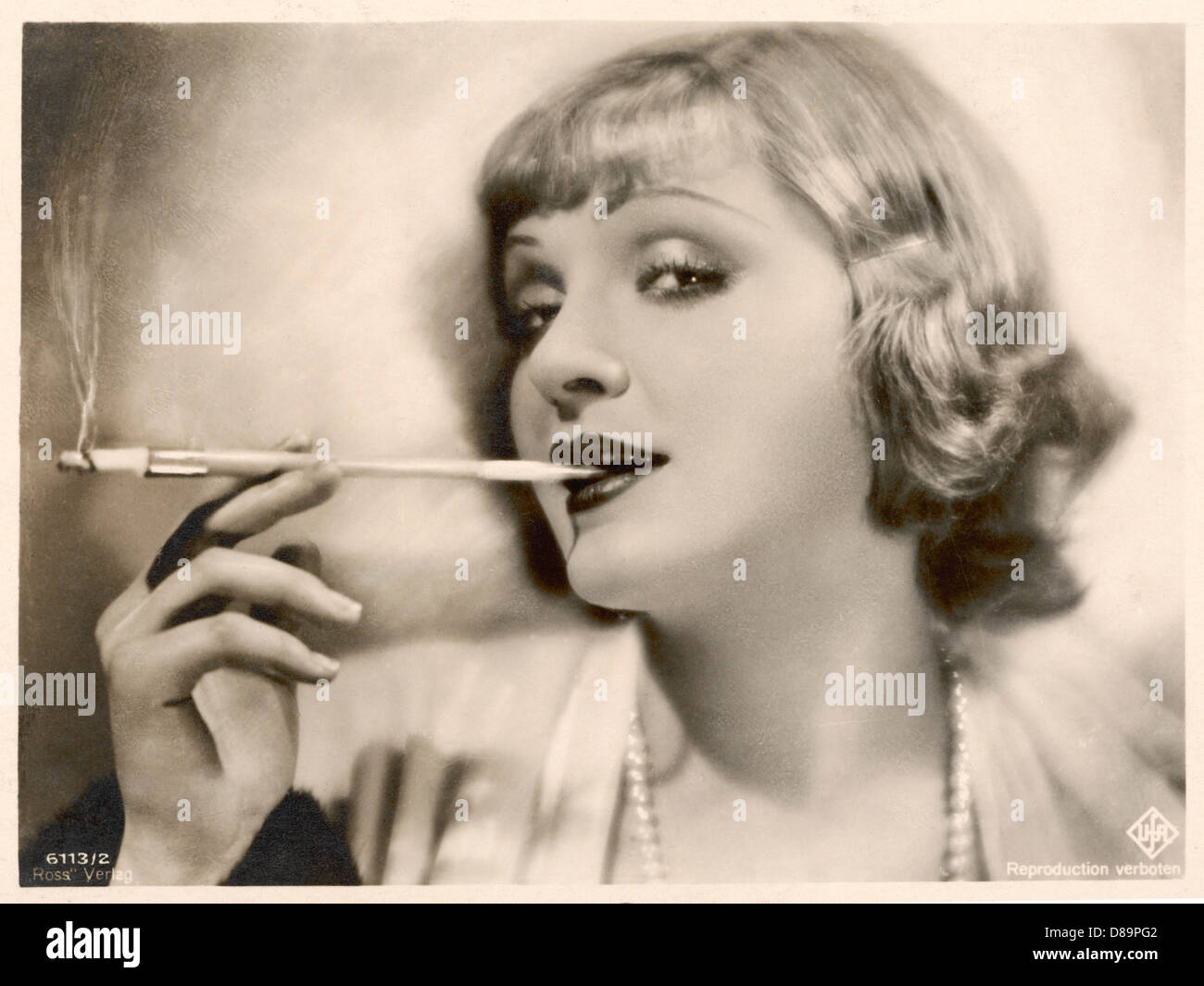 Smoking cigarette with holder hi-res stock photography and images - Alamy