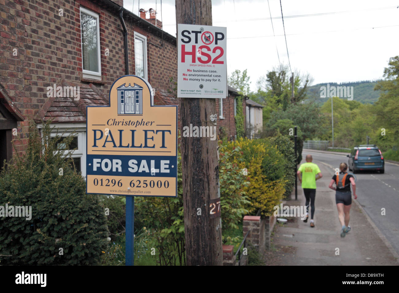 A "Stop HS2" poster on a telephone pole beside a house "for sale" sign ...