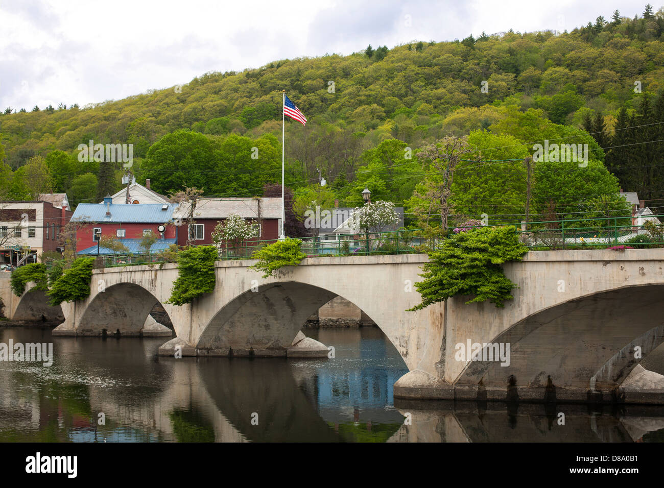 The calm Deerfield river reflects the Shelburne Falls Bridge of Flowers ...
