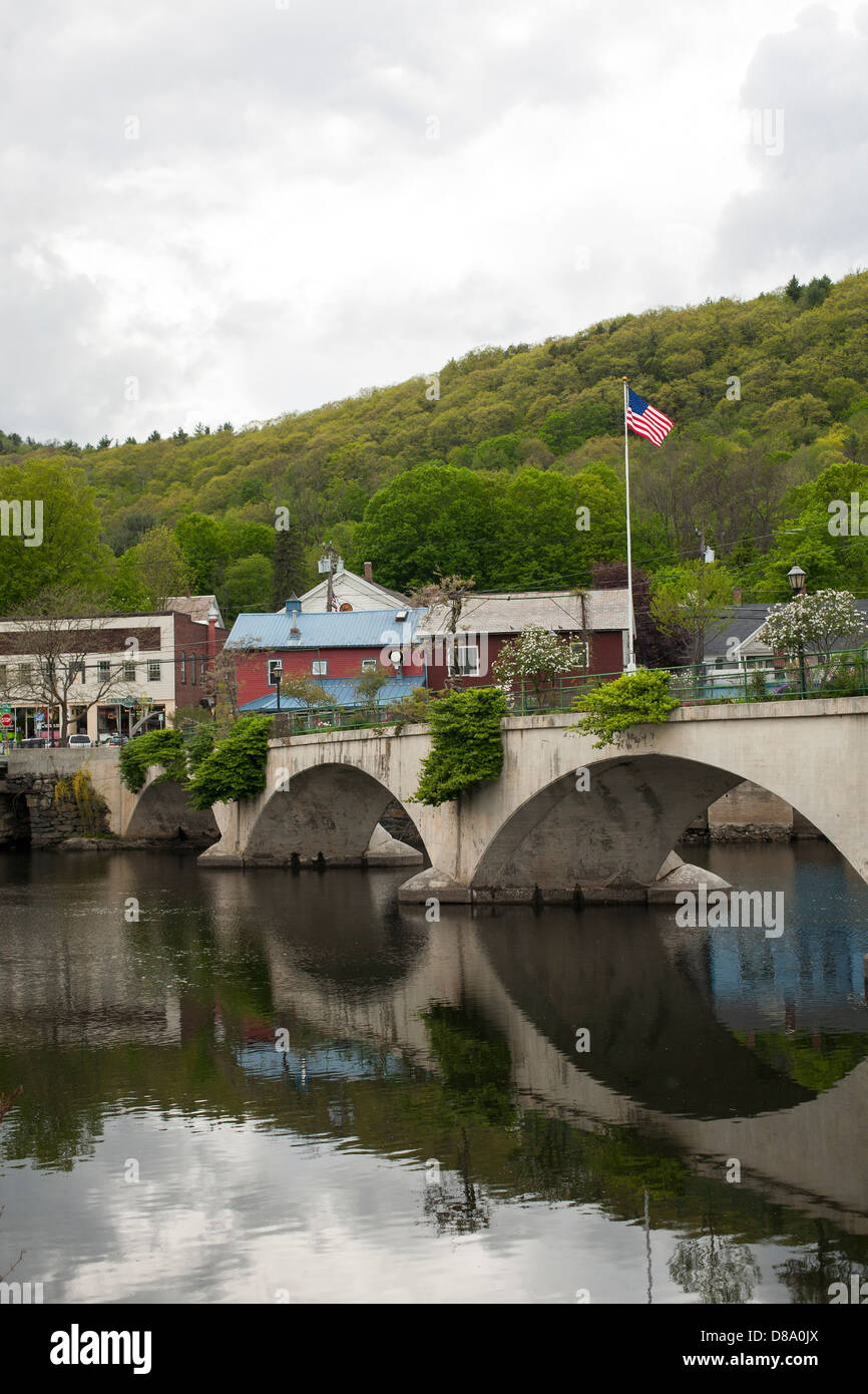 The calm Deerfield river reflects the Shelburne Falls Bridge of Flowers ...