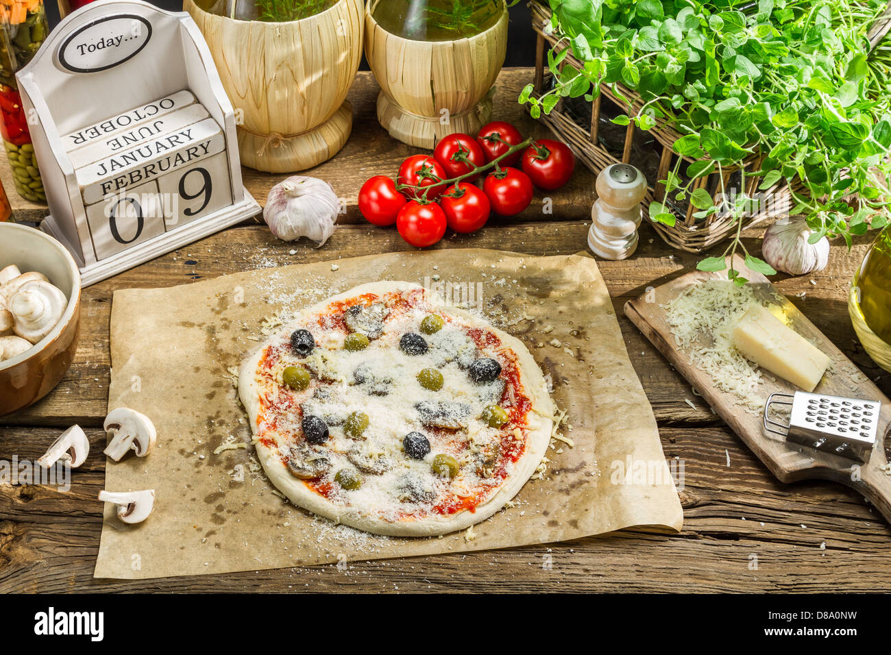 Prepared pizza with fresh ingredients ready to cooking Stock Photo - Alamy