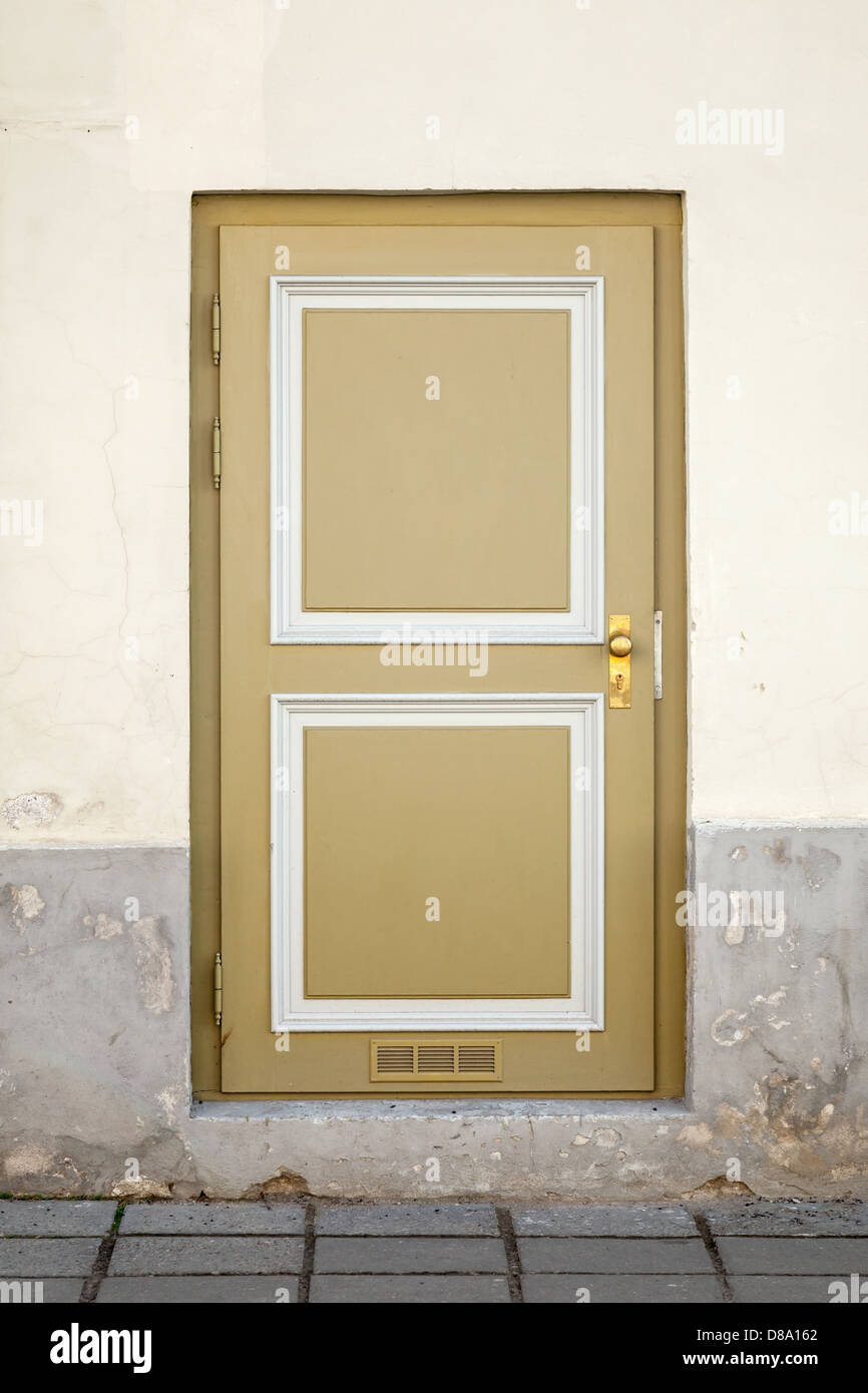 Old wooden door with square elements in old building facade. Tallinn ...