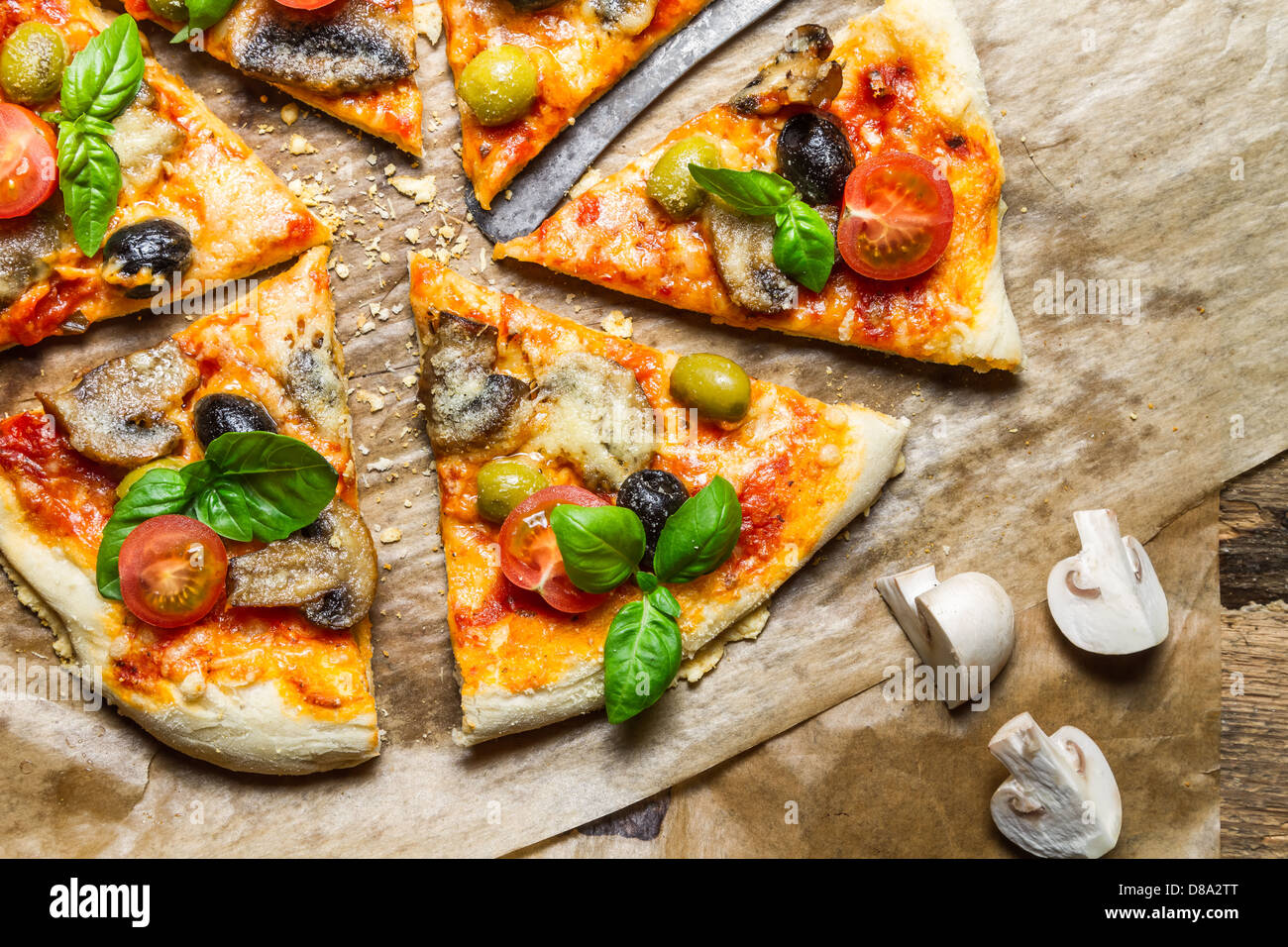 Close-up on a freshly split a pizza Stock Photo - Alamy