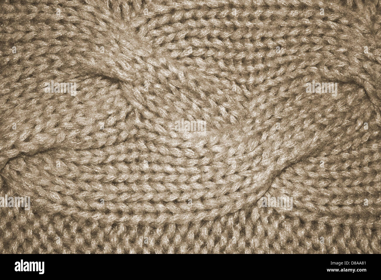 A close-up view of beige cable knit pattern texture, commonly used in ...