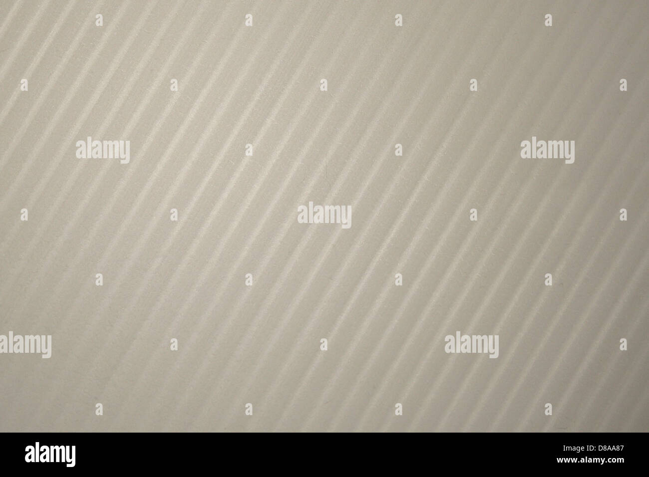 A close-up image of a beige plastic texture with diagonal stripes. The ...